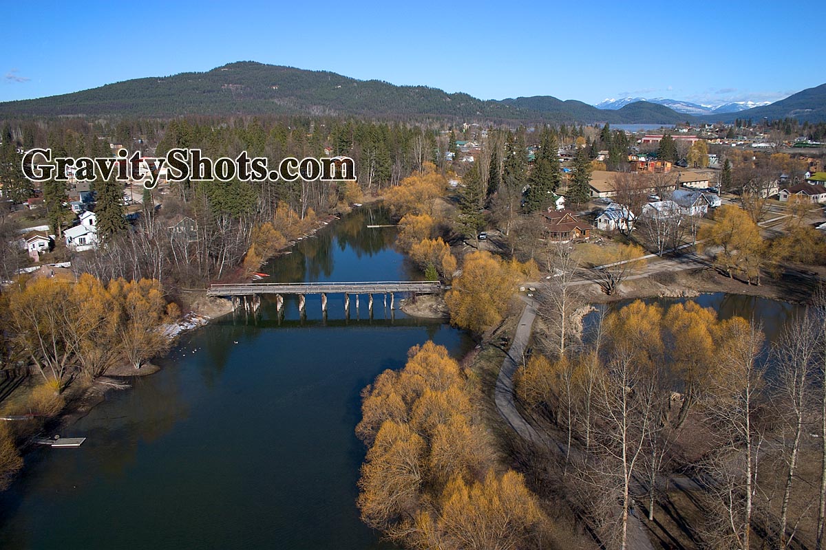 Riverside park bridge Whitefish, MT Spring Aerial - GravityShots.com